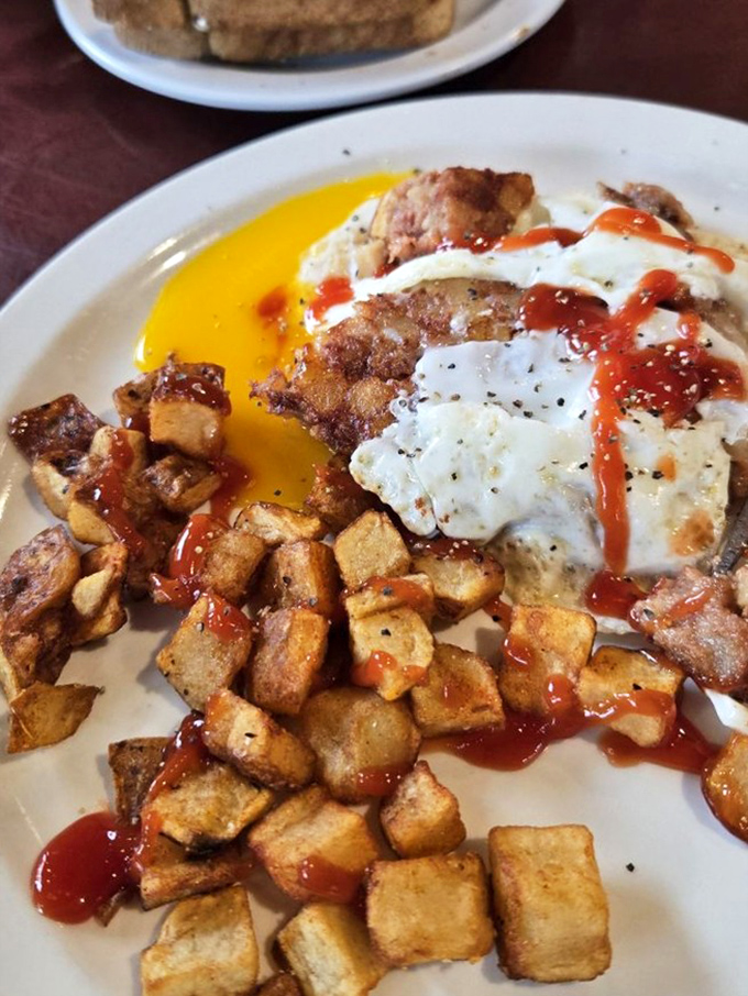 Home fries, eggs, and a splash of hot sauce&mdash;breakfast's holy trinity served with a side of "why don't I make this at home?" (Because it wouldn't taste this good.)