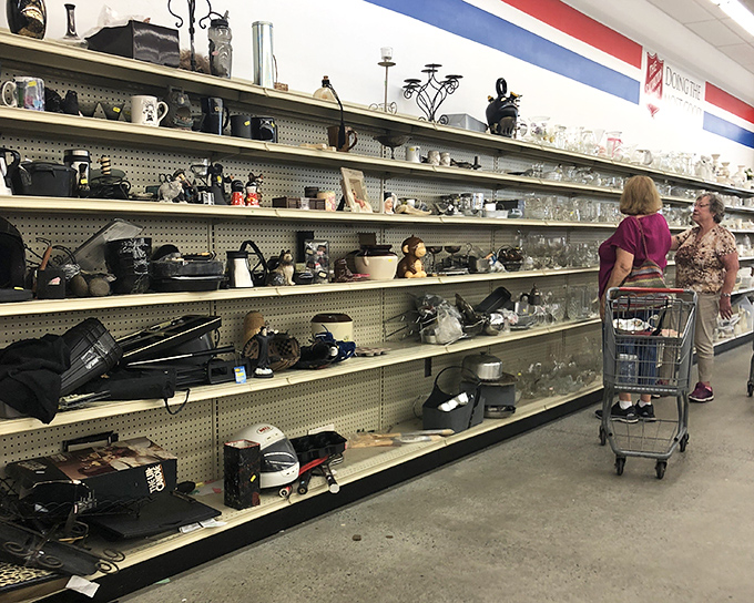 Housewares heaven stretches along well-stocked shelves. Two shoppers contemplate which kitchen treasures might deserve a second life in their homes.
