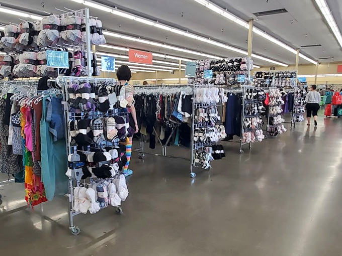 Rows of colorful socks and clothing hang neatly in a well-lit aisle at Value Village, offering budget-conscious shoppers a fun and affordable way to refresh their wardrobe basics.