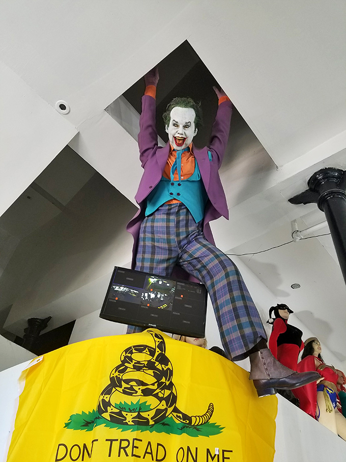The Joker dangles precariously from the ceiling, his maniacal grin suggesting he's either plotting Gotham's demise or spotted the gift shop's discount section.