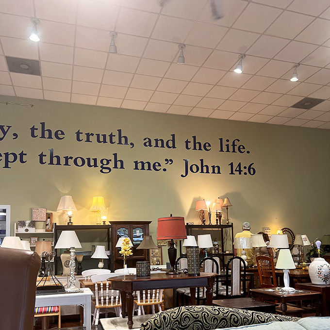 The lamp section glows with potential. Biblical inspiration adorns the walls while practical illumination fills the shelves below.
