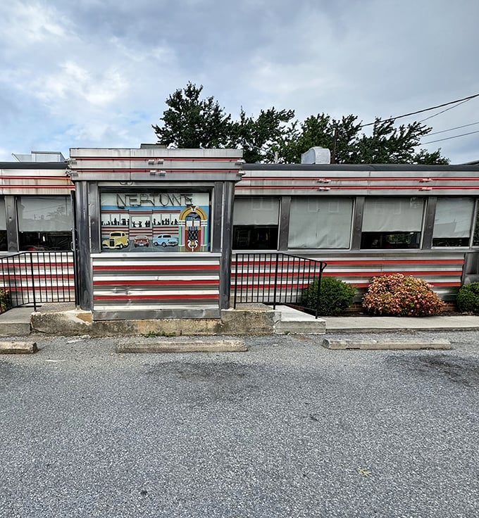 The diner's iconic facade stands as a chrome-clad sentinel, guarding recipes that have remained unchanged while the world outside constantly shifts.