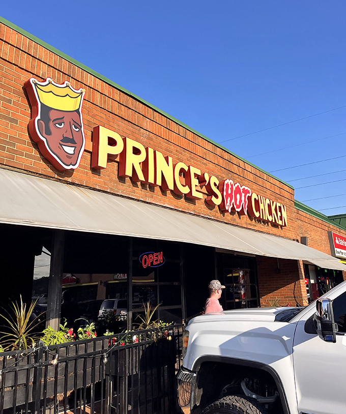 The iconic Prince's signage glows against blue sky, a beacon for spice pilgrims making their mandatory Nashville food pilgrimage.