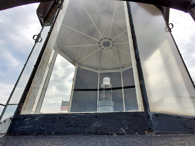 The lighthouse's modern beacon may lack the romance of oil lamps, but it still faithfully guides ships through Michigan's dark waters.