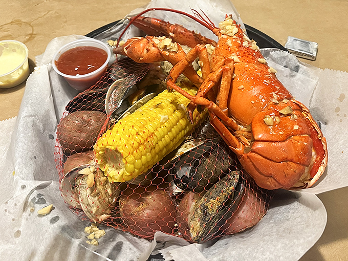 When a lobster arrives with corn and potatoes in tow, it's not just dinner&mdash;it's a coastal celebration wrapped in a convenient mesh bag.