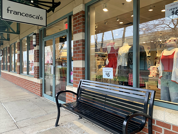 Francesca's storefront beckons with trendy finds while benches offer weary shoppers strategic rest stops.