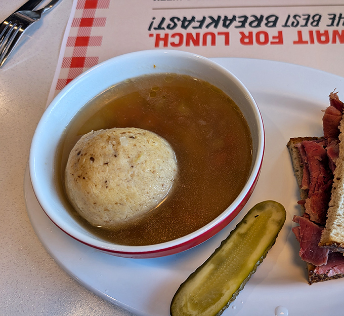 A matzo ball floating like the moon in a savory universe&mdash;this soup has been solving problems since before therapy was invented.