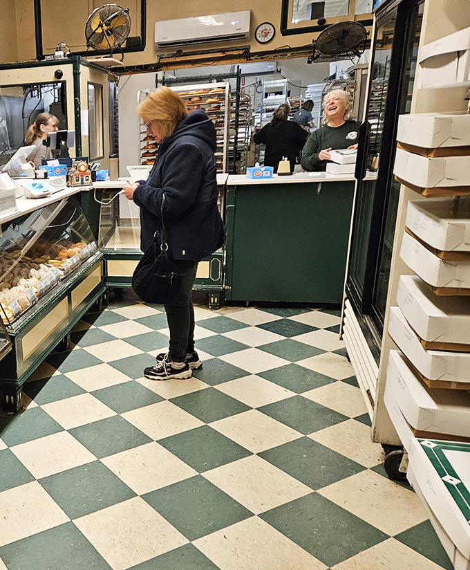 No Instagram filters needed in this authentic donut sanctuary. The checkered floor has witnessed generations of sugar-seekers making their life-changing pastry decisions.