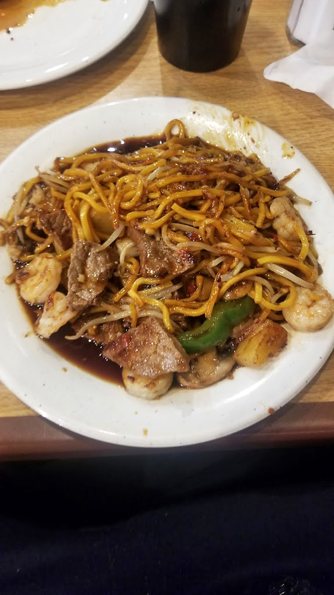 This isn't your college dorm room noodle dish. It's a symphony of textures with tender shrimp, crisp vegetables, and perfectly cooked noodles.