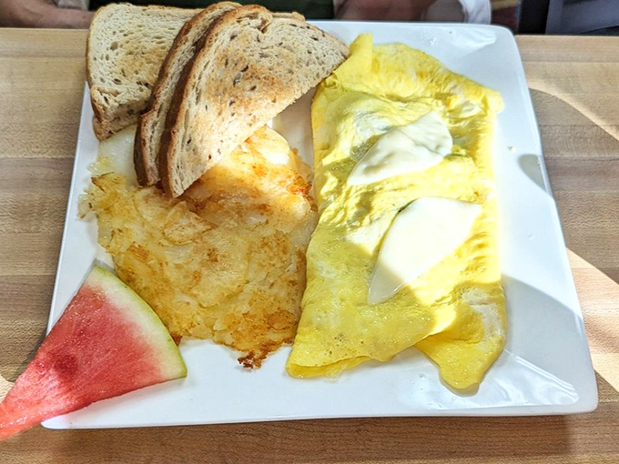 This omelet practically glows with cheesy goodness, while those hash browns have achieved that perfect crisp-tender ratio that so many breakfast spots miss.