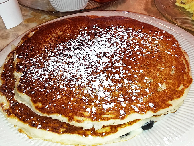 Pancakes so perfectly golden they deserve their own Instagram account. That dusting of powdered sugar is the breakfast equivalent of fairy dust.