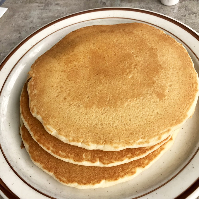 Stack of pancakes so perfectly golden, they could make IHOP weep with envy and admiration combined.