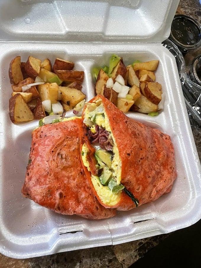 Breakfast potatoes that could make a potato farmer weep with joy, flanking a wrap that's practically bursting with morning goodness.