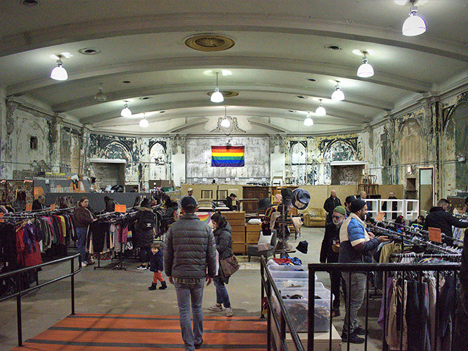 The theater's architectural details create a dramatic backdrop for bargain hunting. Where once audiences watched films, shoppers now search for their own starring pieces.