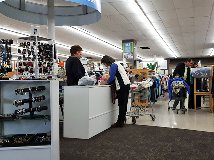 The checkout area: where friendly volunteers transform your pile of treasures into the best retail therapy session money barely has to buy.