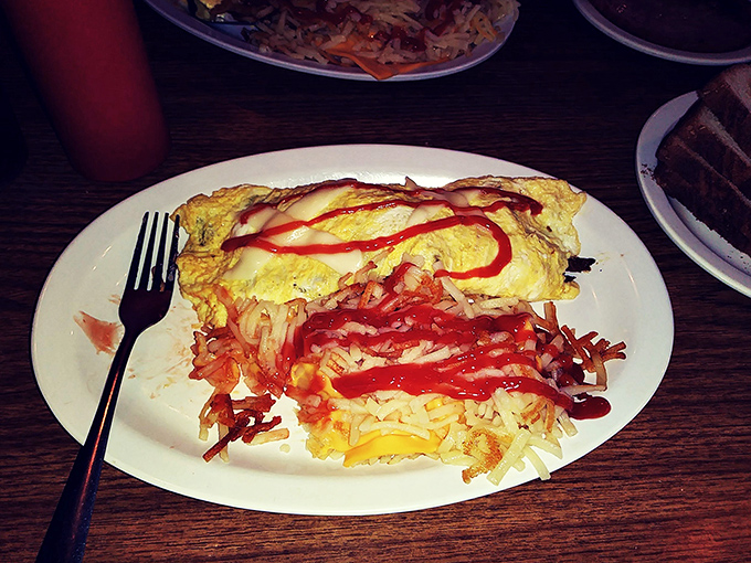 When an omelet and a Philly cheesesteak have a beautiful baby. That squiggle of ketchup is like the bow on a present.
