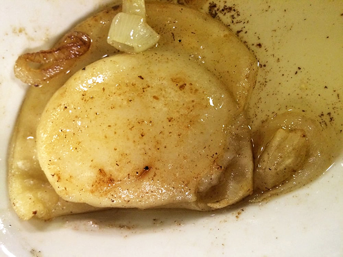 Comfort food that whispers, "Everything's going to be okay." This pierogi is bathing in buttery goodness like it's at a five-star spa.