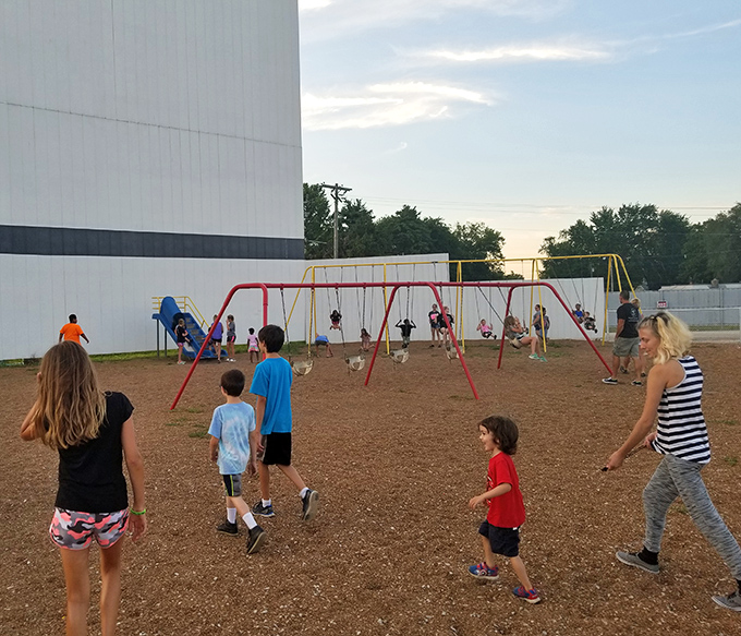 Pre-movie energy burn station in action. Smart parents know the playground is the secret to kids actually making it through the second feature.