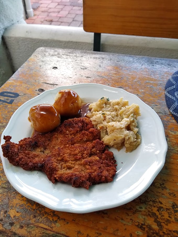 Schnitzel so perfectly golden it deserves its own Olympic medal, accompanied by potato dumplings that could make a grown German weep.