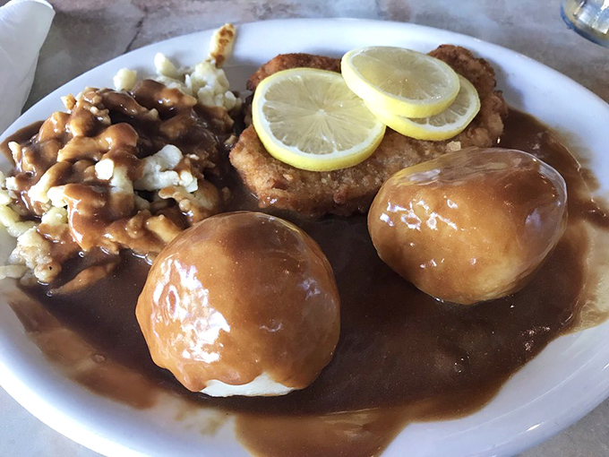 These potato dumplings swim in rich gravy alongside perfectly golden schnitzel&mdash;a plate that whispers "take a nap after lunch" in the most delicious way possible.