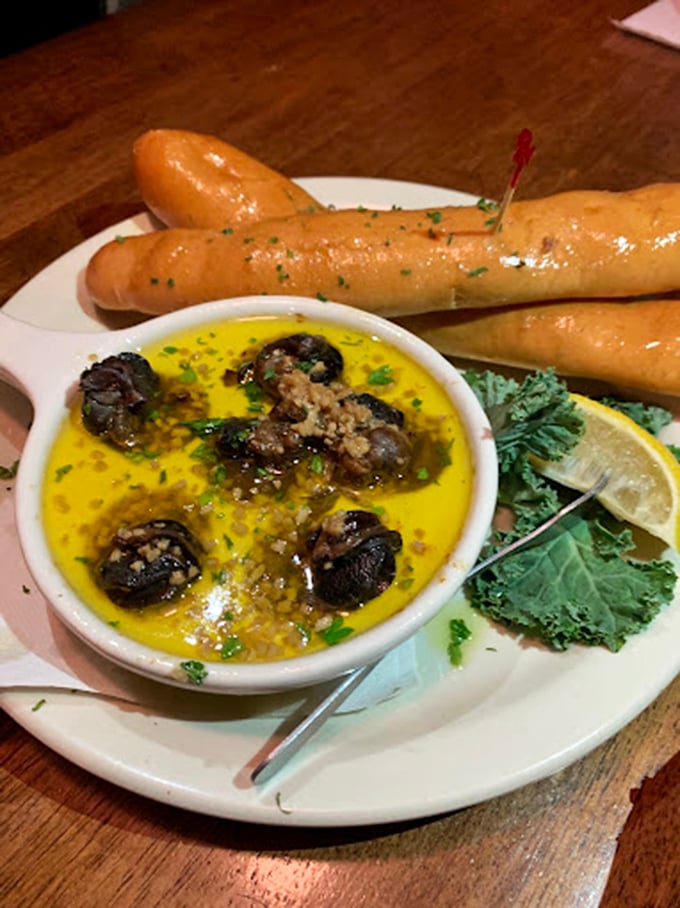 Escargot swimming in garlic butter with breadsticks standing by for essential sopping duties. Fancy without being pretentious.