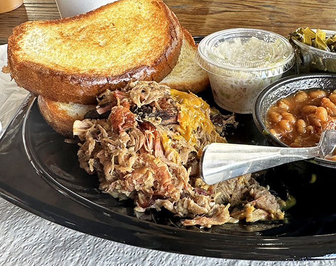 This pulled pork sandwich with slaw and beans isn't just lunch&mdash;it's edible evidence that patience and smoke create magic that fast food can never match.