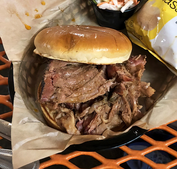 This pulled pork sandwich isn't just a meal&mdash;it's an architectural marvel of tender meat that somehow manages to maintain its dignity despite being irresistibly sloppy.