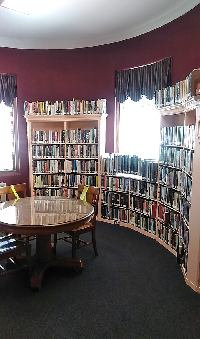 The circular reading room, with its rich burgundy walls, feels like stepping into a Victorian novel. Even the curved bookshelves add dramatic flair.