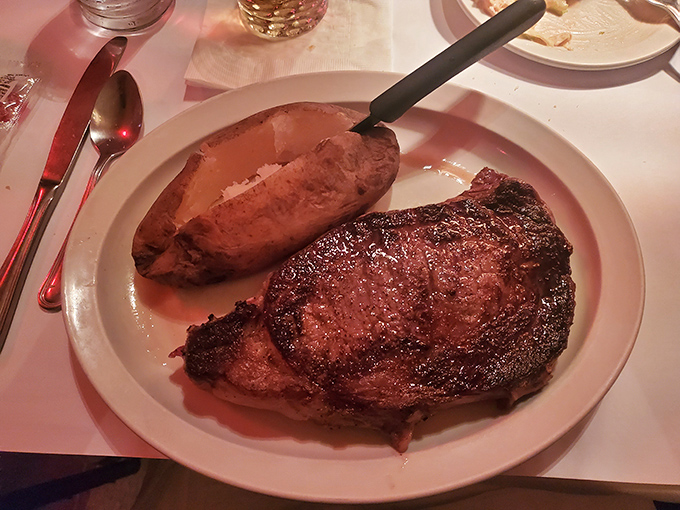 The ribeye arrives like a magnificent island in a sea of white porcelain, with green beans standing by as the perfect supporting cast.