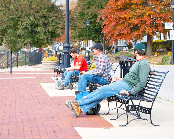 Nothing says "small-town America" quite like three guys on a bench, solving the world's problems one river view at a time.