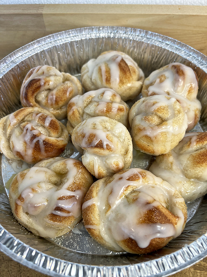 Cinnamon rolls with personality—each one a spiral of sweetness topped with glaze that's having its own little waterfall moment.