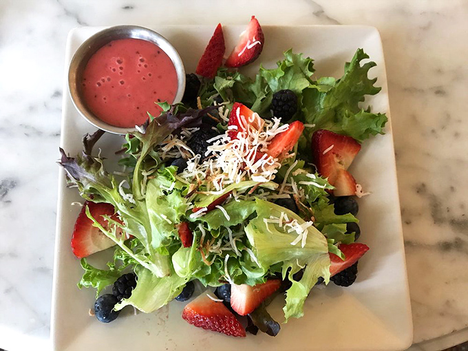 A salad that actually excites – fresh berries and greens with a blush-colored dressing that makes eating vegetables feel like breaking the rules.