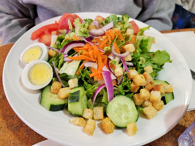 A salad that actually makes you forget you ordered the French toast too. Crisp, colorful, and those homemade croutons deserve their own fan club.