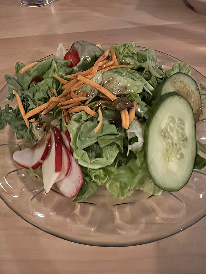A garden-fresh salad that doesn't feel like punishment. Crisp vegetables, sharp cheese, and a dressing that makes eating greens feel like cheating.