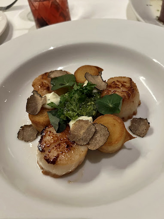 Scallops seared to golden perfection, with truffle shavings that don't just whisper luxury—they announce it with a megaphone.