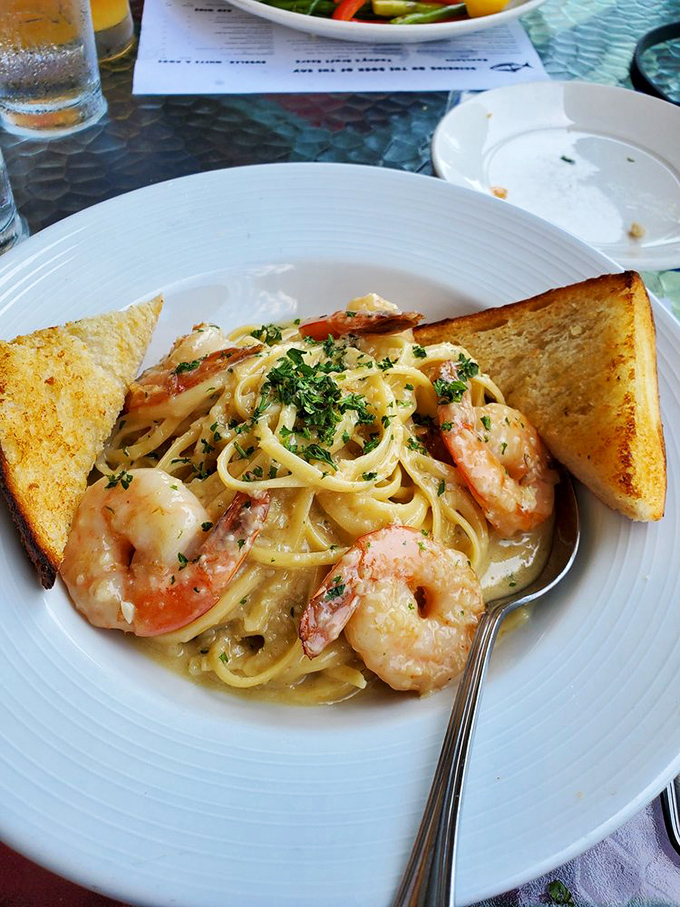 Shrimp scampi that makes you question why you'd ever order anything else. Those perfectly toasted bread triangles aren't just sides&mdash;they're essential sauce-sopping tools.