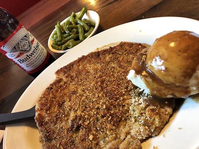 A schnitzel so perfectly golden-brown it deserves its own trophy, accompanied by mashed potatoes that clearly weren't born from a box.