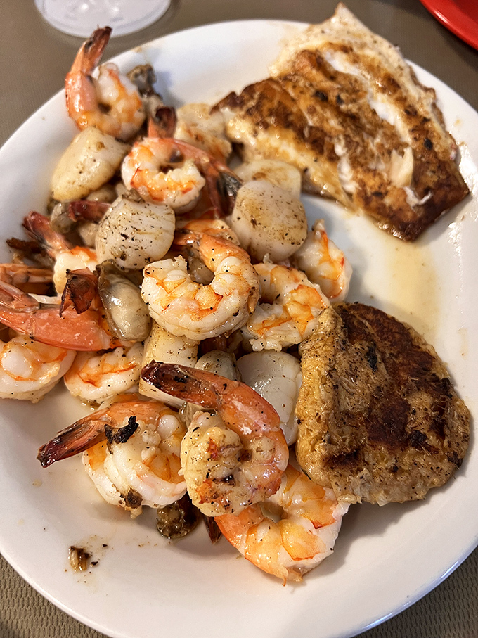 The seafood trifecta &ndash; plump shrimp, delicate scallops, and that crab cake again, proving that sometimes the best things come on plain white plates.