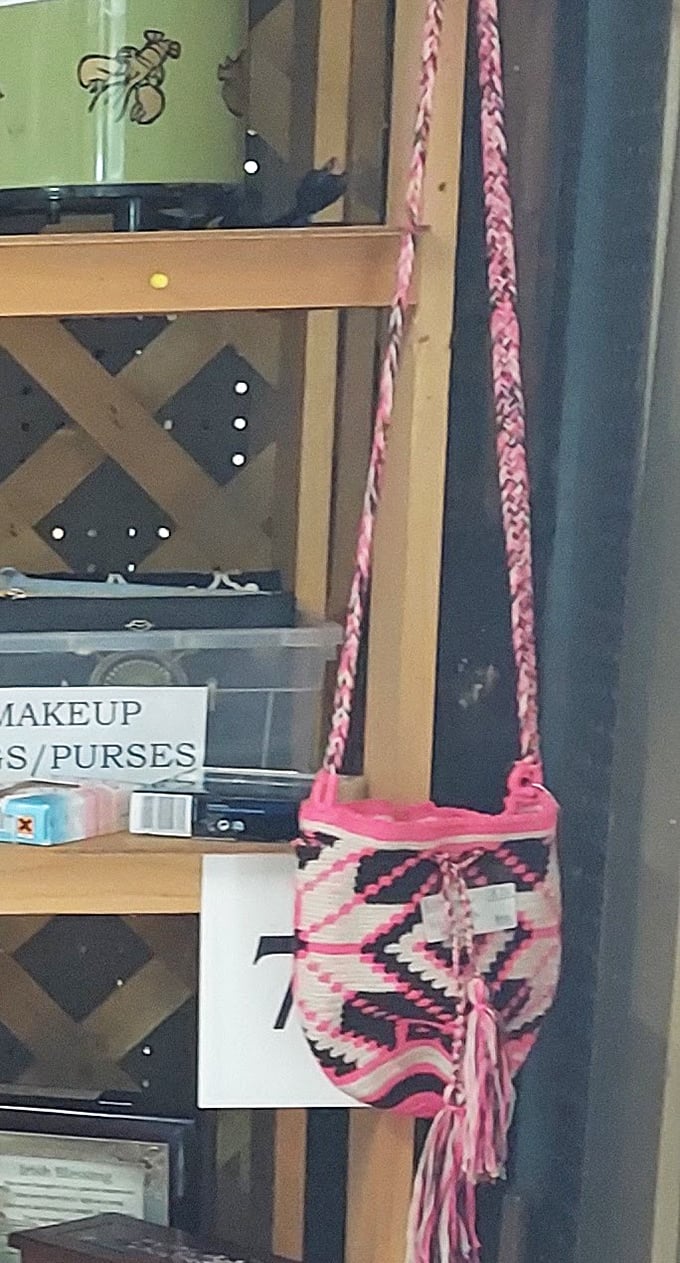 Handcrafted pink and black woven bag dangles with possibility. Someone's 1970s fashion statement awaits its second act.