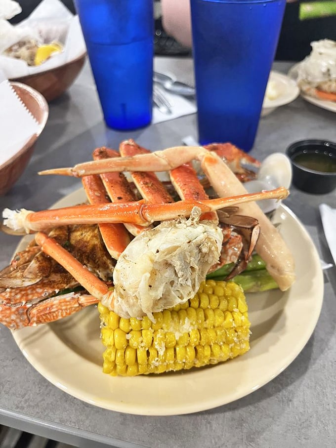 The architecture of indulgence&mdash;snow crab legs artfully arranged with corn on the cob, creating the seafood equivalent of a royal flush.