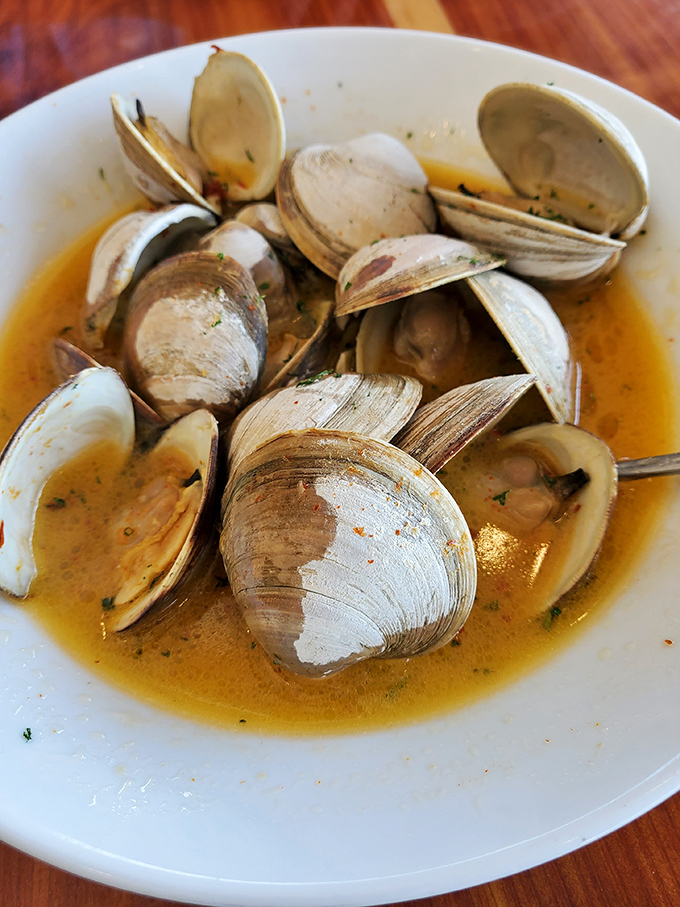 Steamed clams bathing in a broth so good you'll be asking for extra bread for strategic sopping operations.
