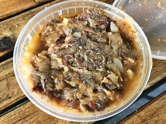 A container of mystery stew that proves the rule: the less photogenic the food, the more spectacular the flavor. This is the kind of dish memories are made of.