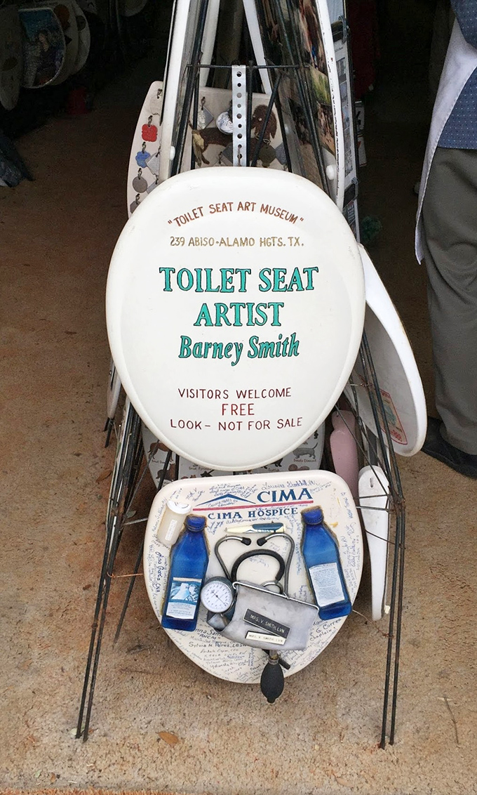 This isn't just a sign—it's a manifesto on toilet seat artistry. Barney's legacy lives on in this most unexpected medium.