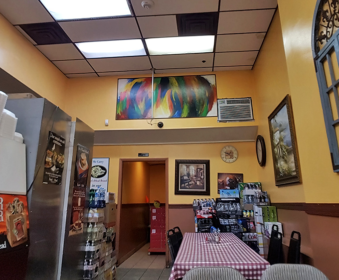 Colorful artwork brightens the walls while red-checkered tablecloths add that touch of diner nostalgia we all secretly crave.