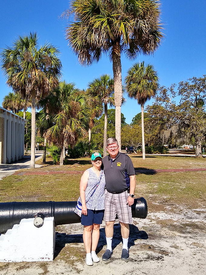The park's historic cannon provides the perfect backdrop for visitors creating memories against Florida's living history canvas.