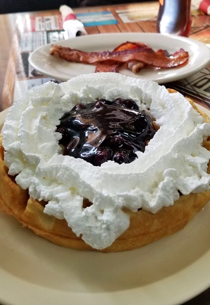 Waffle architecture at its finest&mdash;a sturdy foundation supporting whipped cream mountains and a blueberry compote lake. Breakfast or dessert? Why choose?