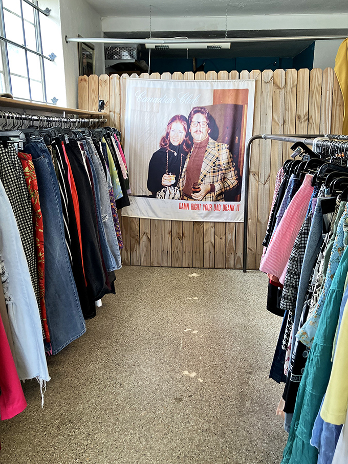 Denim alley leads to a blast from the past. Between these racks of jeans and colorful bottoms hangs a retro poster reminding us of questionable fashion choices.