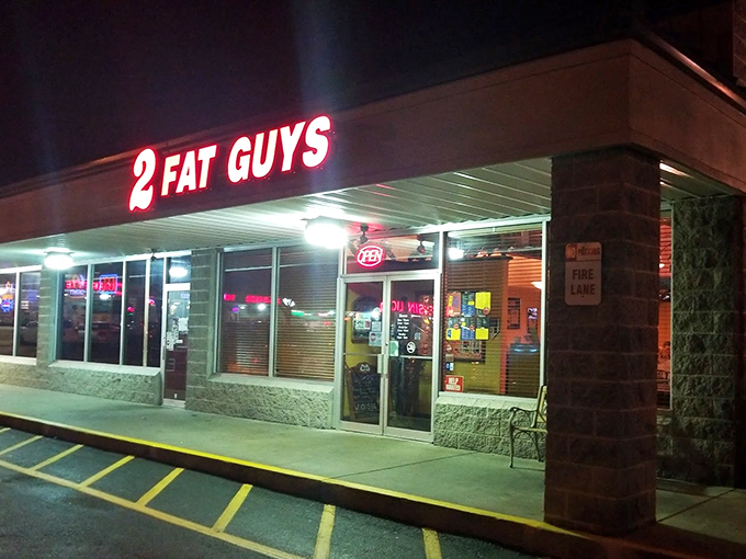 2 Fat Guys' glowing sign beckons hungry travelers like a burger lighthouse in the night. Follow the light!