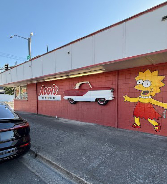 Addi's Diner's vibrant red exterior and playful murals promise a breakfast experience that's anything but ordinary.
