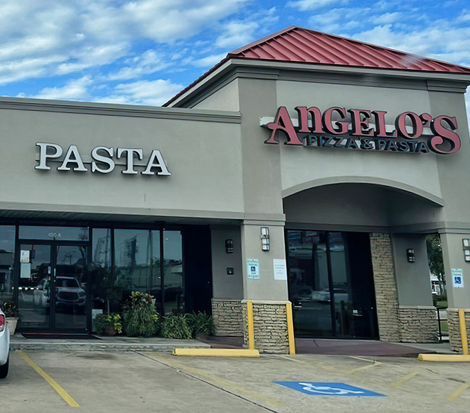 Angelo's Pizza and Pasta: That bold red sign against the beige building is like a dinner bell for pizza lovers. No frills, just thrills for your taste buds! 
